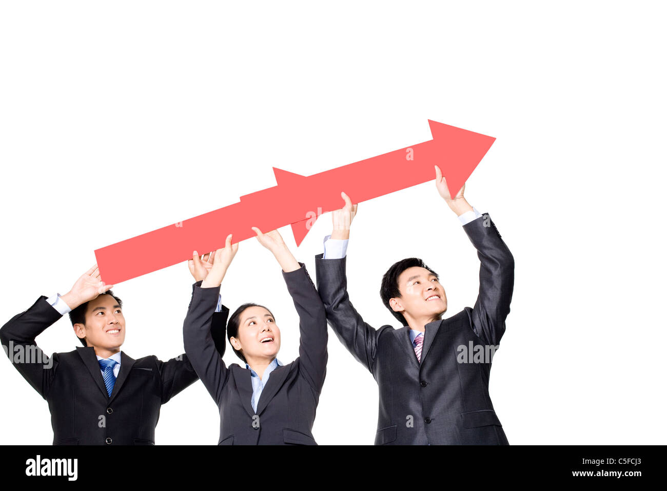 Business partners holding up red arrow sign Stock Photo - Alamy