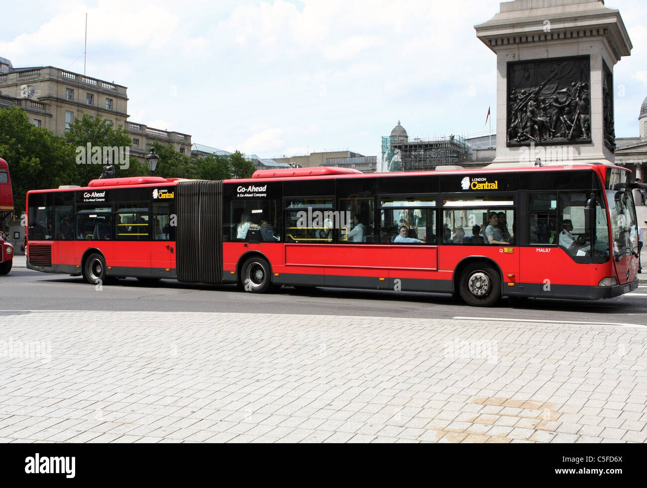 A bendy bus traveling around Trafalgar Square, London Stock Photo - Alamy