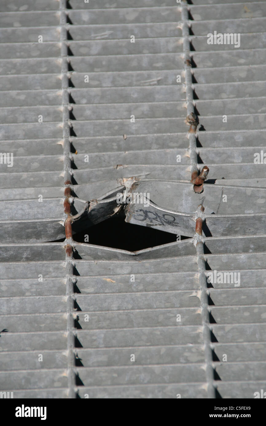 damaged metal steel gate fence grill mesh with hole Stock Photo - Alamy