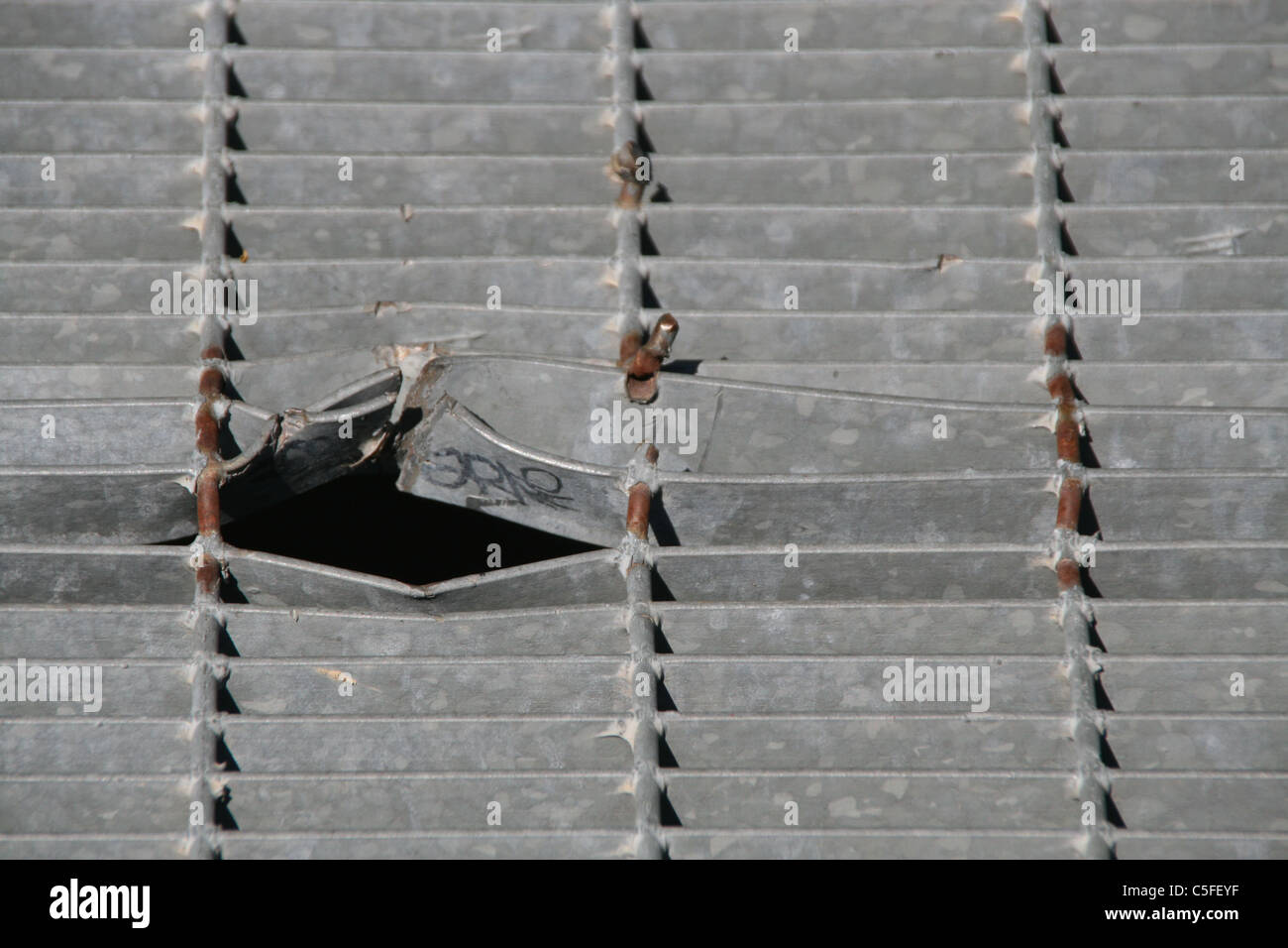 damaged metal steel gate fence grill mesh with hole Stock Photo - Alamy