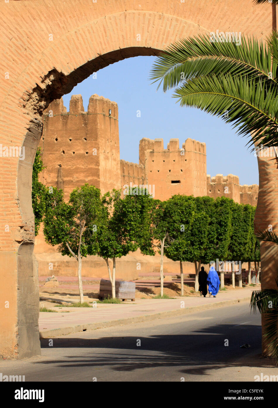 Keyhole gateway or Bab, looking to two women walking by the city walls ...