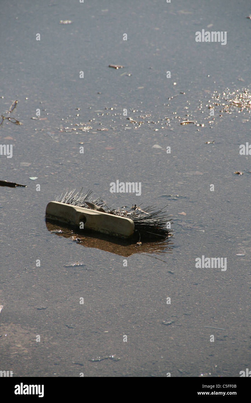 old brush abandoned in pool of water on derelict ground Stock Photo - Alamy