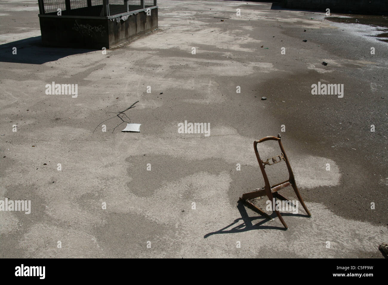 one damaged broken wooden chair on derelict ground Stock Photo - Alamy