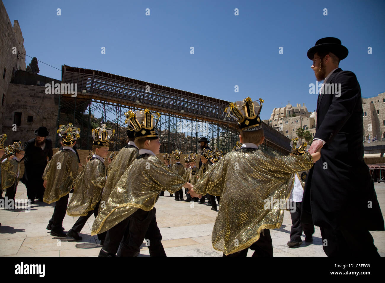 Ultra Orthodox religious Jews dancing next to the renovation site of ...