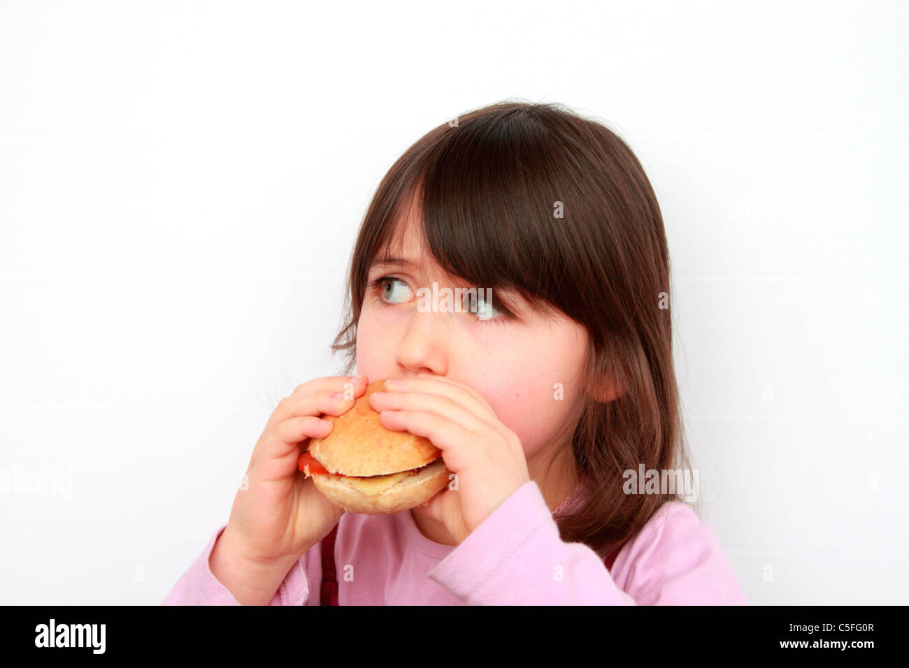 Girl eating a roll Stock Photo - Alamy