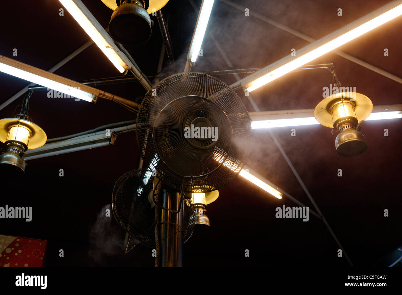 Fan pushing out wet air in hawker stalls in Singapore Stock Photo - Alamy