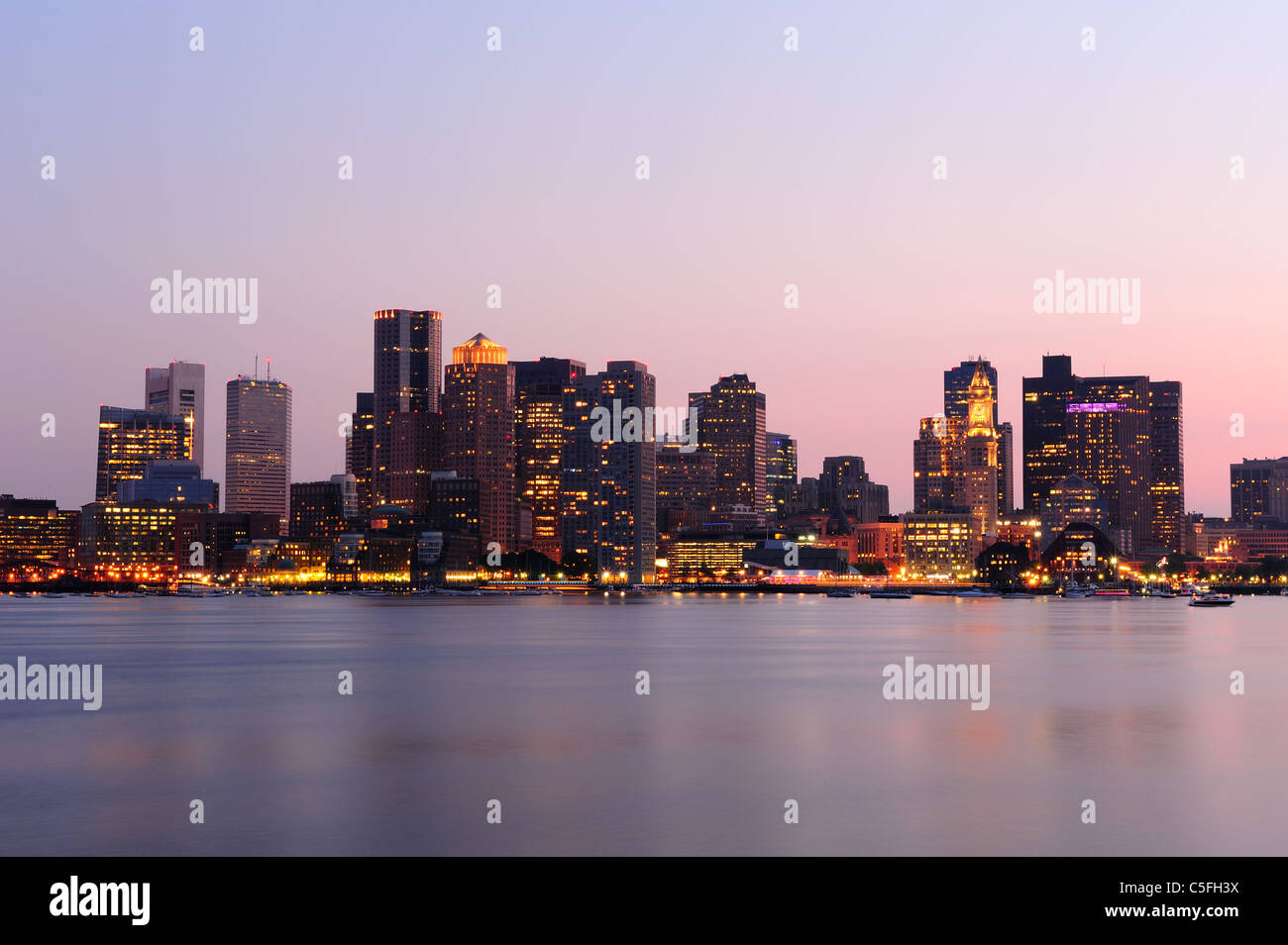 Boston downtown at dusk with urban buildings illuminated at dusk after ...