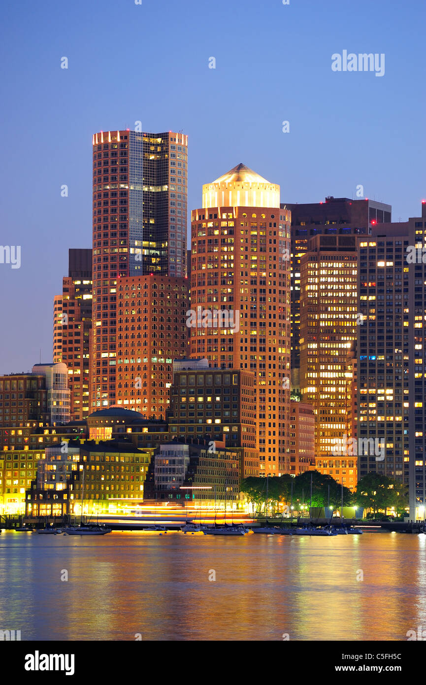 Boston downtown at dusk with urban buildings illuminated at dusk after ...