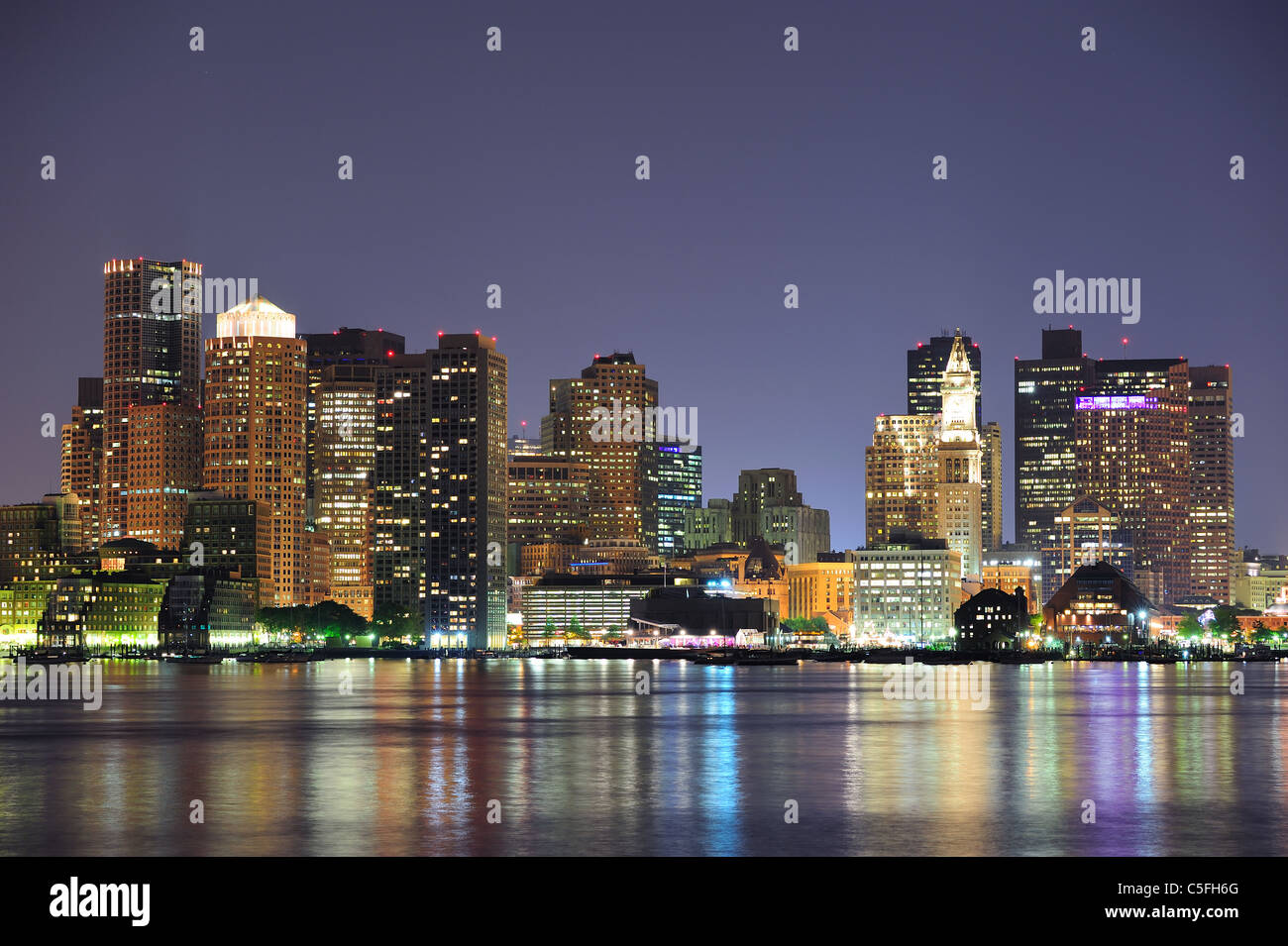Boston downtown at dusk with urban buildings illuminated at dusk after ...