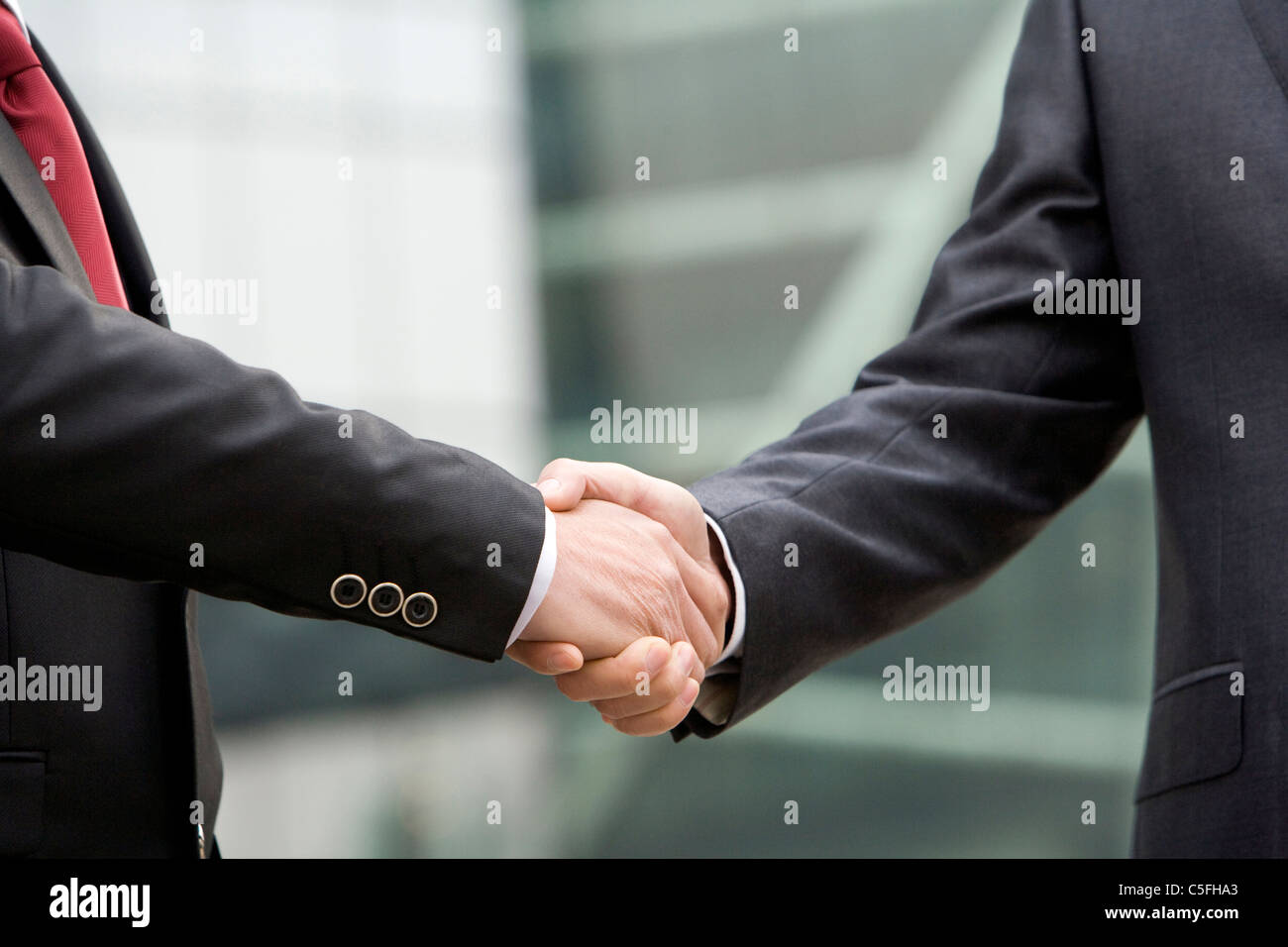 Businessmen shaking hands Stock Photo - Alamy
