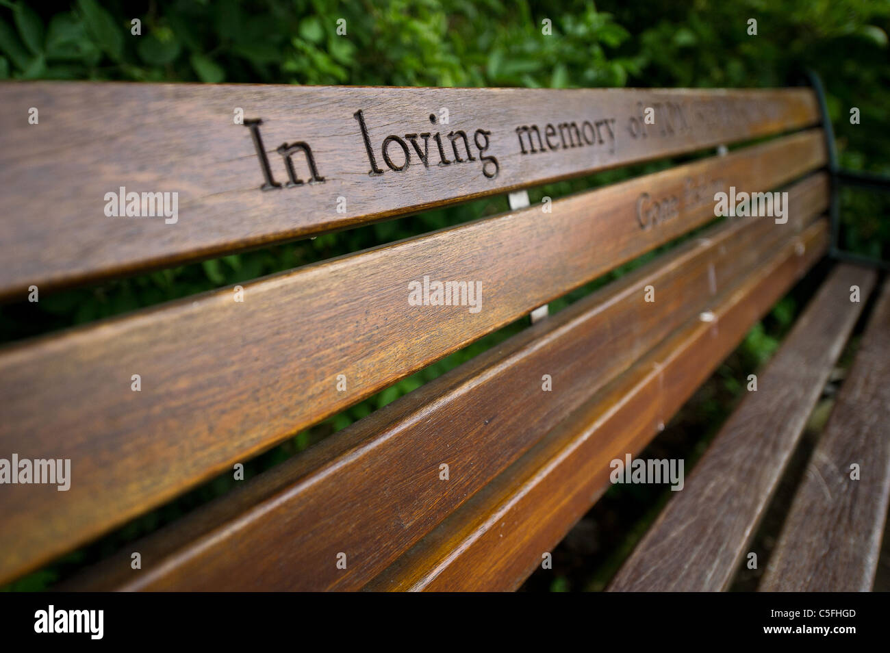 A dedication carved into a wooden bench Stock Photo - Alamy