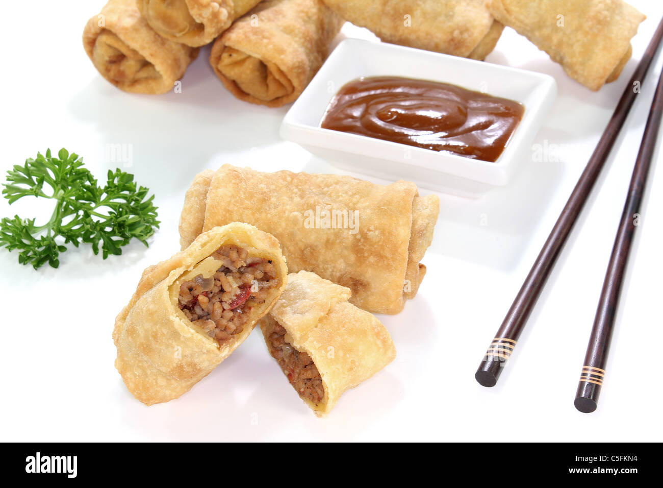 Spring rolls with ground beef, tomatoes, parsley and garlic on a white ...