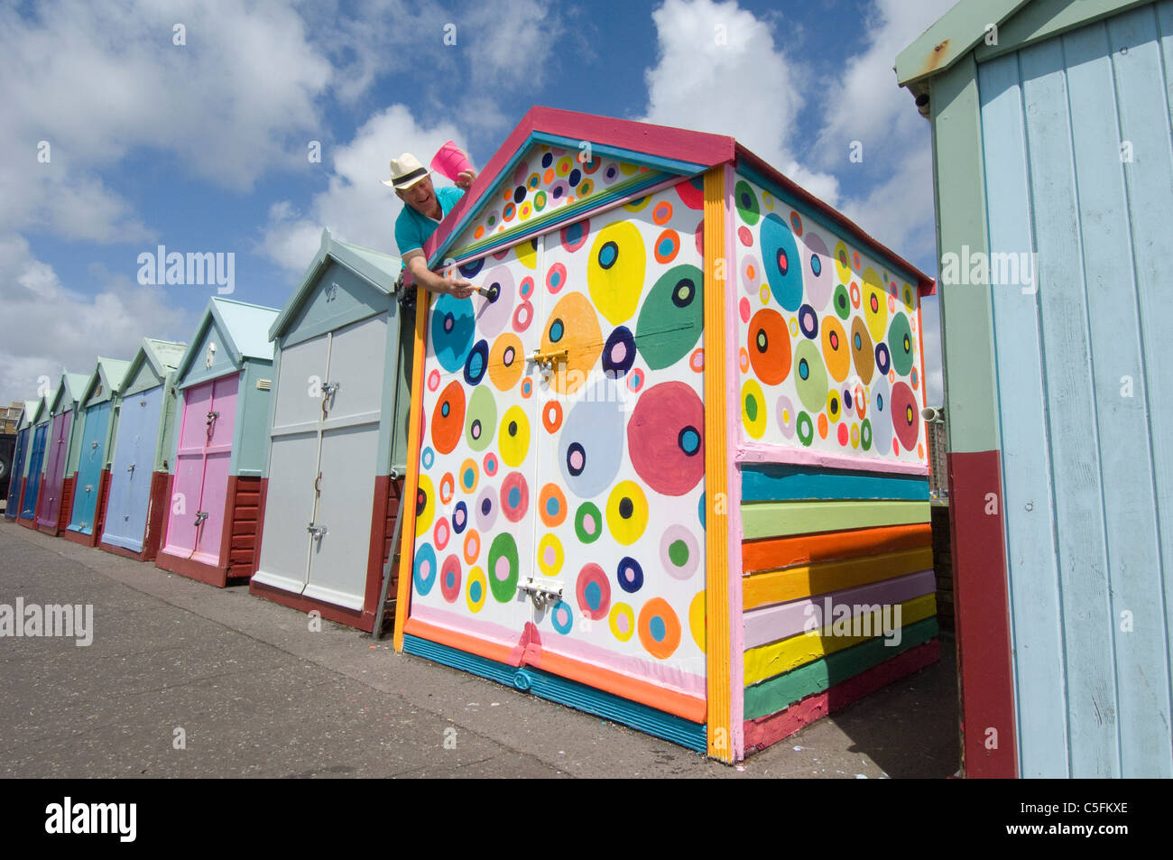 A middle aged man defying rules and painting his Brighton beach hut in ...