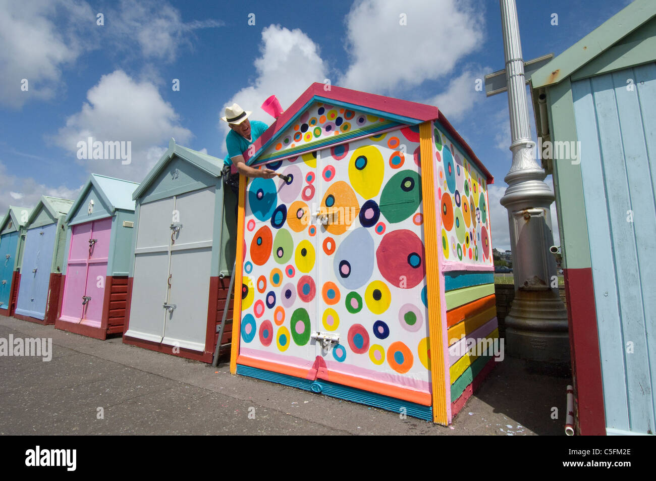 A rebel beach hut owner painting his hut in non-regulation colours ...