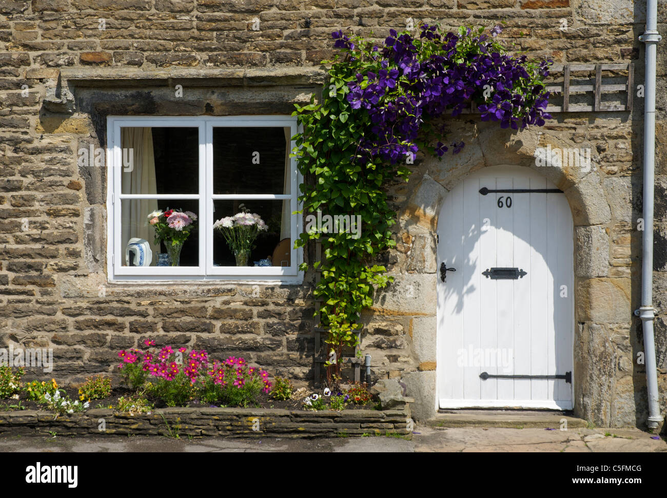 Old stone cottage in the village of Cononley, North Yorkshire, England ...