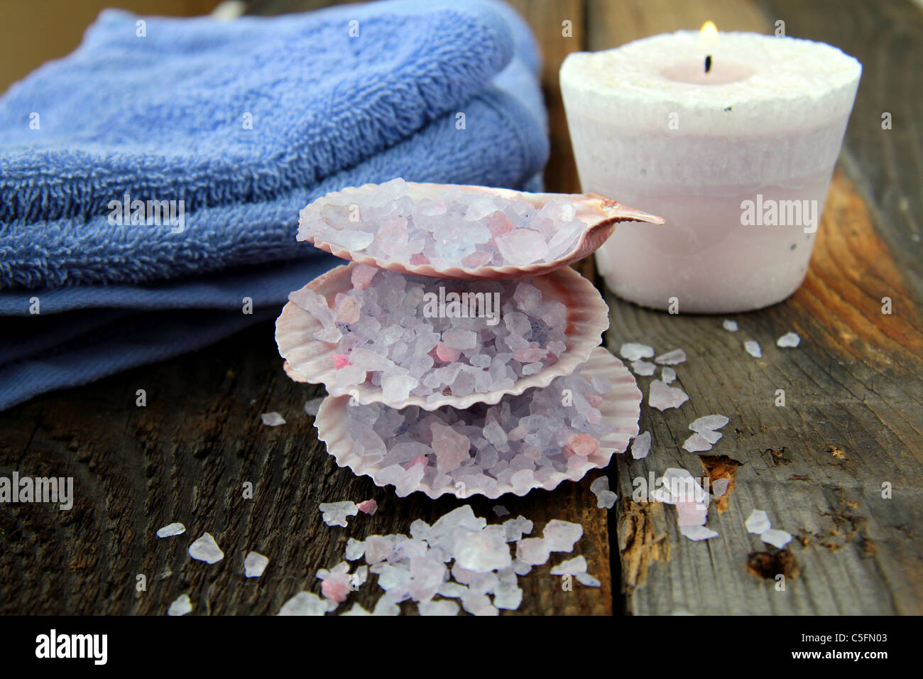 Spa still life .Bath lilac salt, towel and candle Stock Photo - Alamy