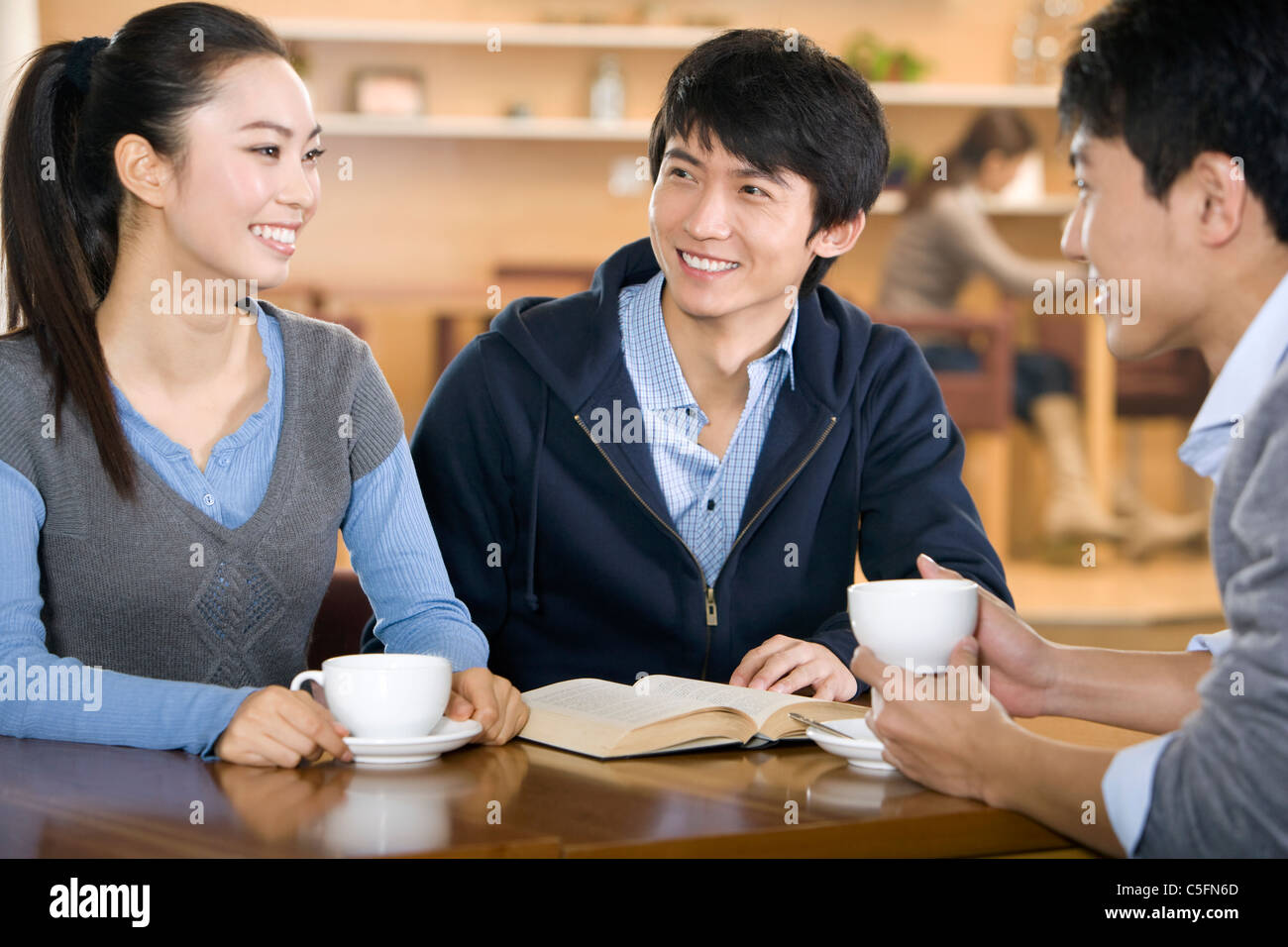 A group of friends talking over coffee Stock Photo - Alamy