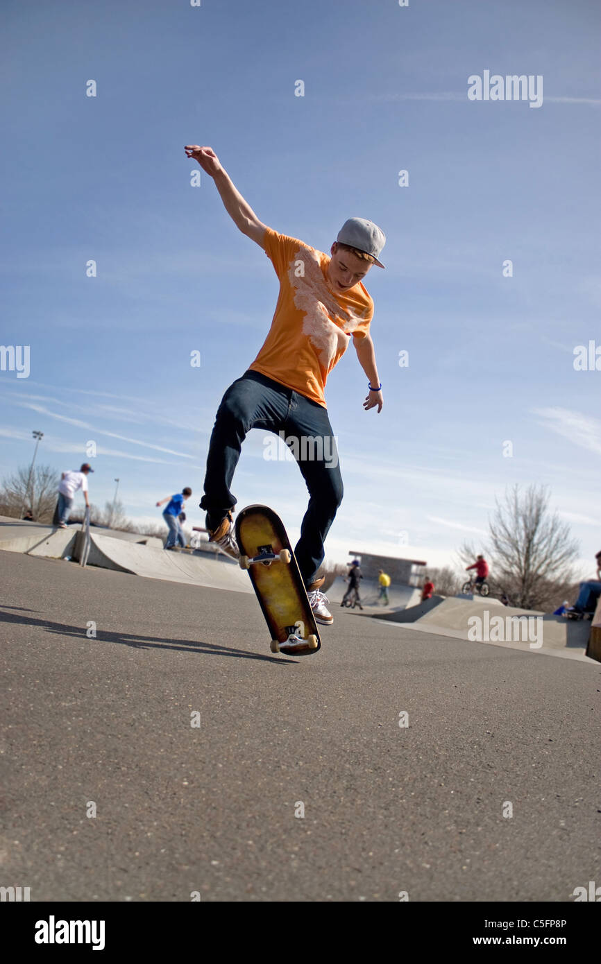 A young skateboarder doing a stunt in a skate park Stock Photo - Alamy