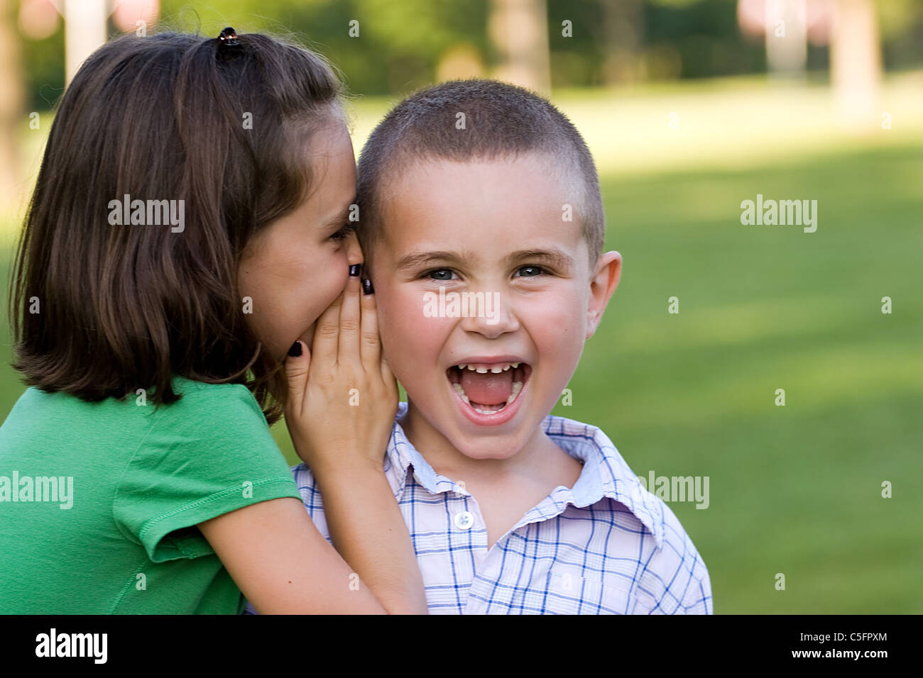 Telling secrets boy hi-res stock photography and images - Alamy