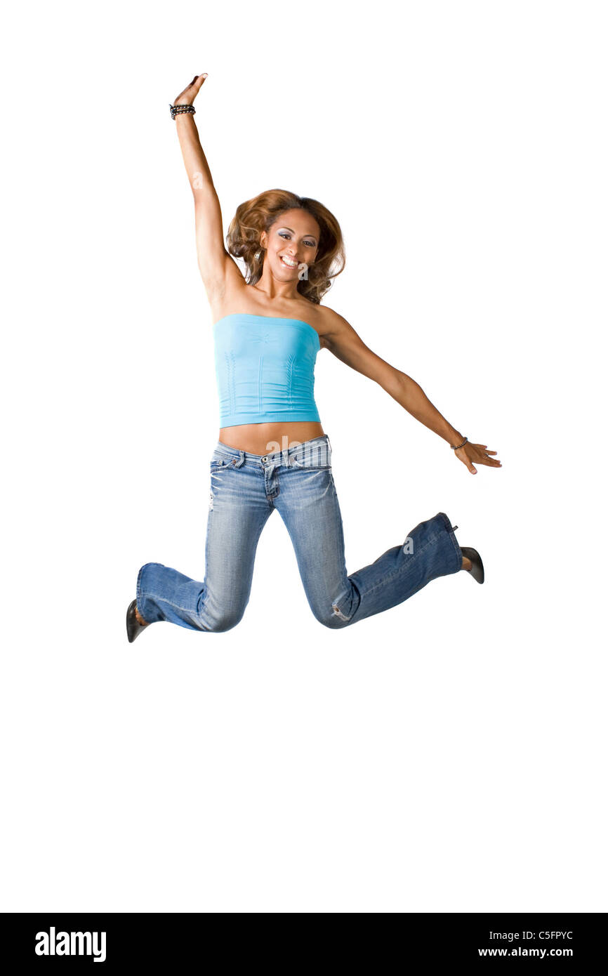 A young woman jumping and having fun. Isolated over a white background ...