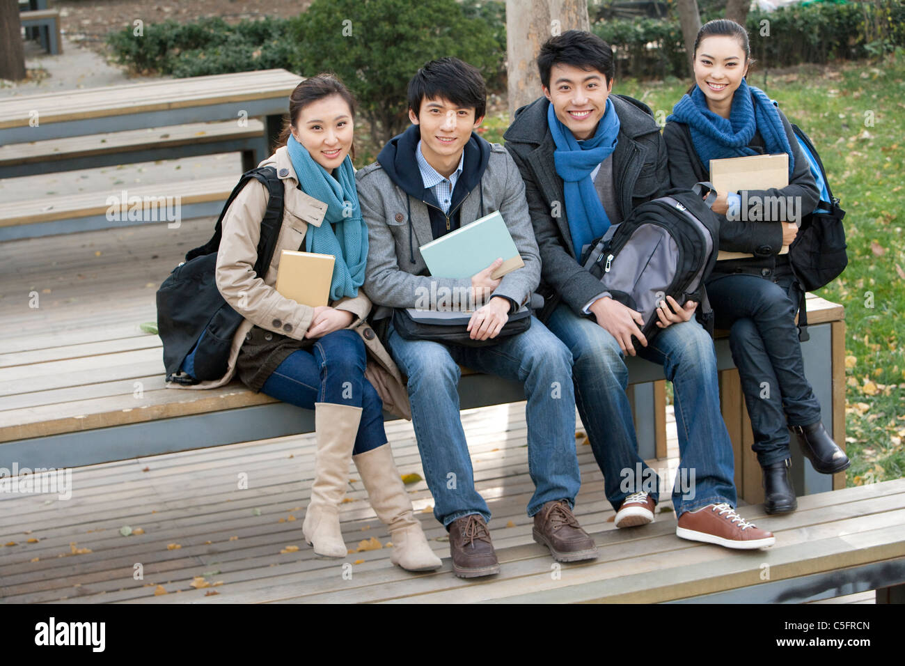 A group of college students sitting on a bench Stock Photo - Alamy