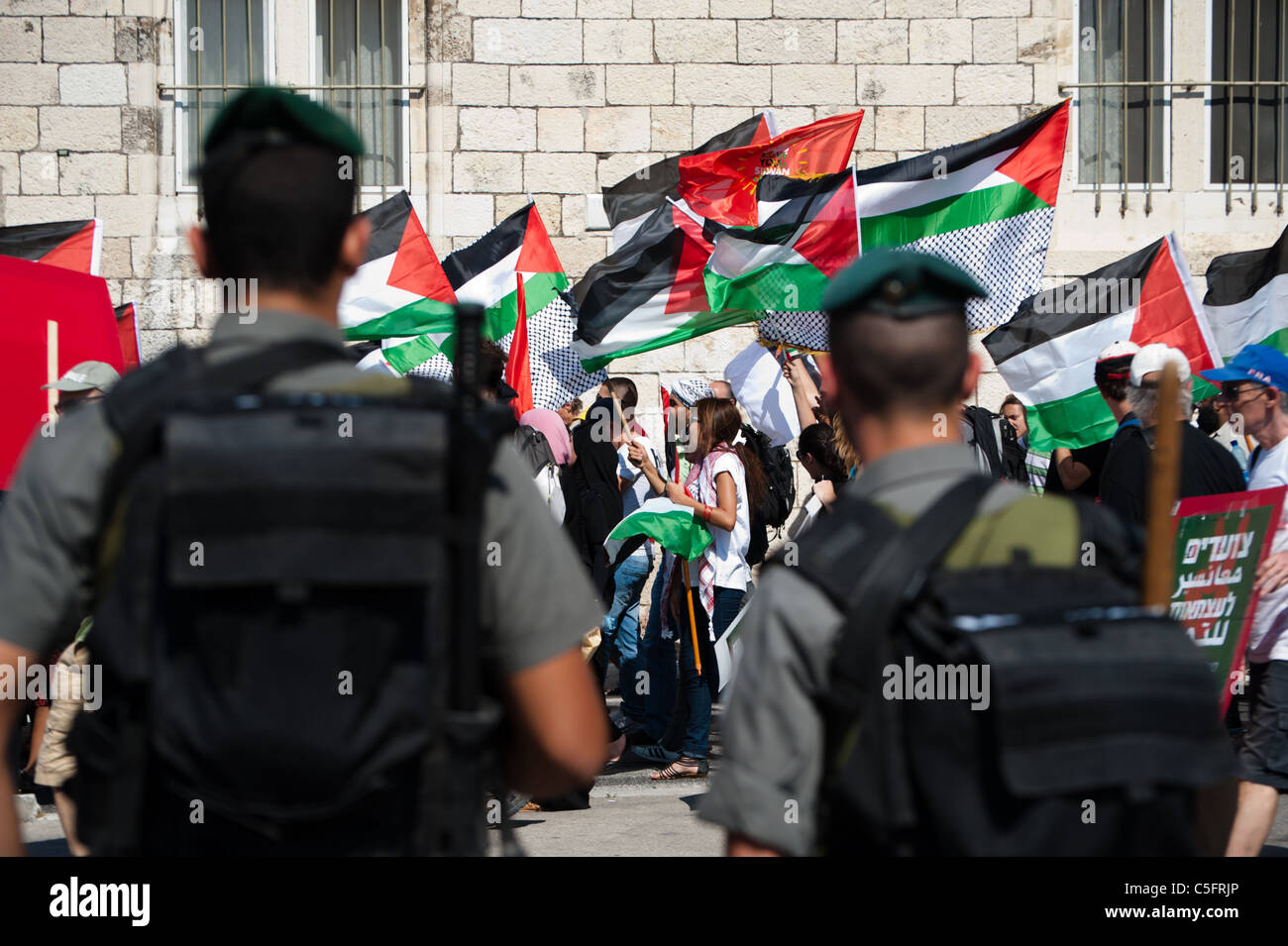 Israeli soldiers stand by a as thousands of solidarity activists march ...