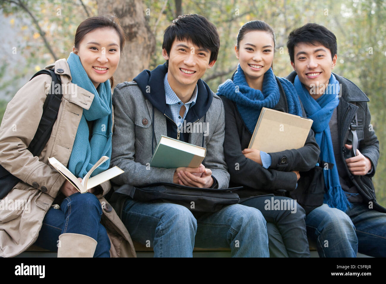A group of college students sitting on a bench Stock Photo - Alamy