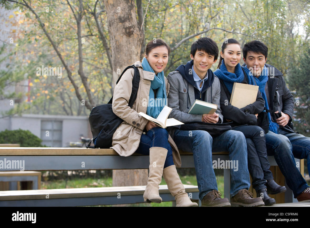 A group of college students sitting on a park bench Stock Photo - Alamy