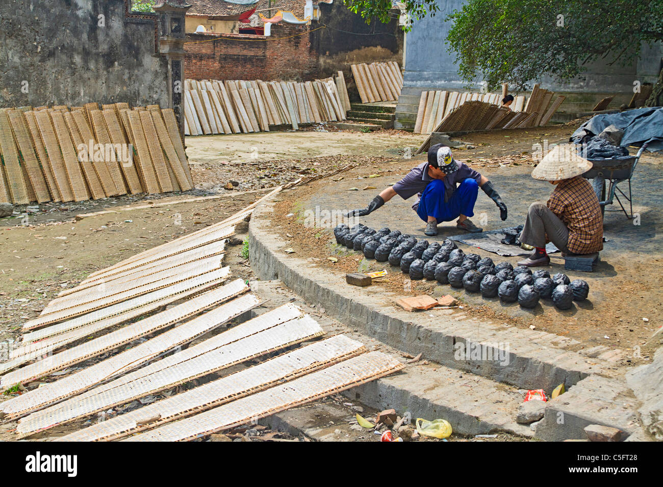 Rice paper (used in cooking) dries on racks while workers make "bee ...
