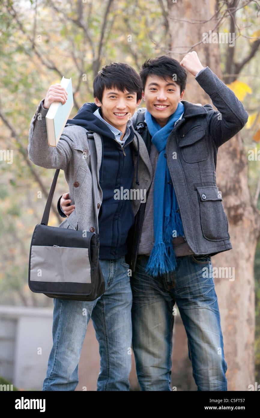 Two college friends celebrating together Stock Photo - Alamy