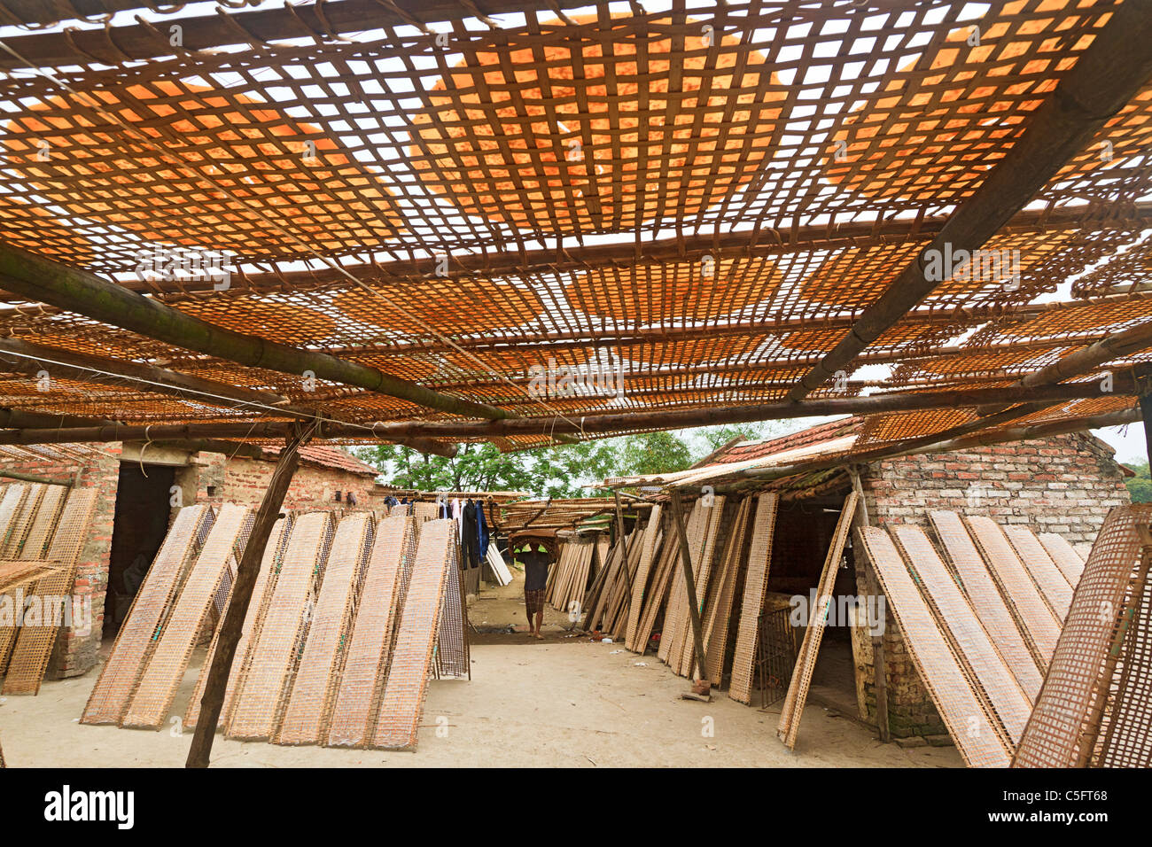 Man Carries Racks Of Rice Paper used In Cooking To Dry On Bamboo Racks In Tho Ha Village On A man-carries-racks-of-rice-paper-used-in-cooking-to-dry-on-bamboo-racks-in-tho-ha-village-on-a
