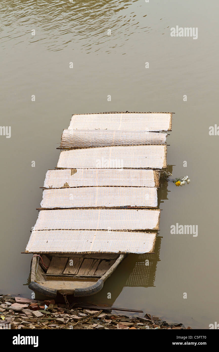 Rice paper (used in cooking) dries on bamboo racks spread across boat ...