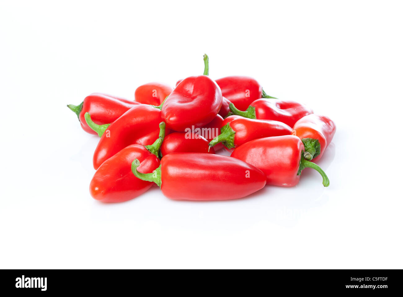 A red baby pepper against a white background Stock Photo - Alamy