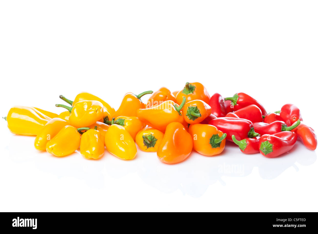 A red baby pepper against a white background Stock Photo - Alamy