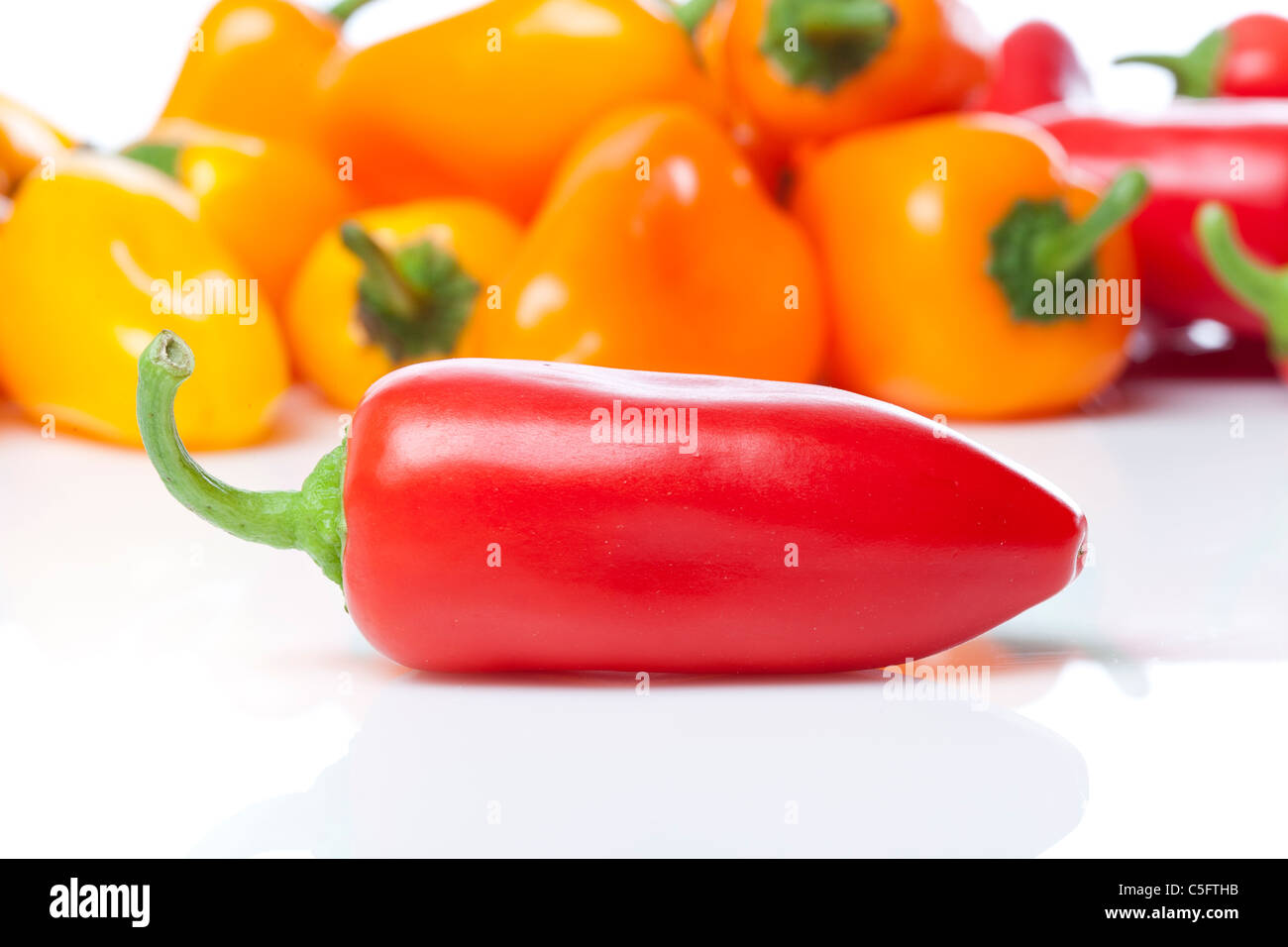 A red baby pepper against a white background Stock Photo - Alamy