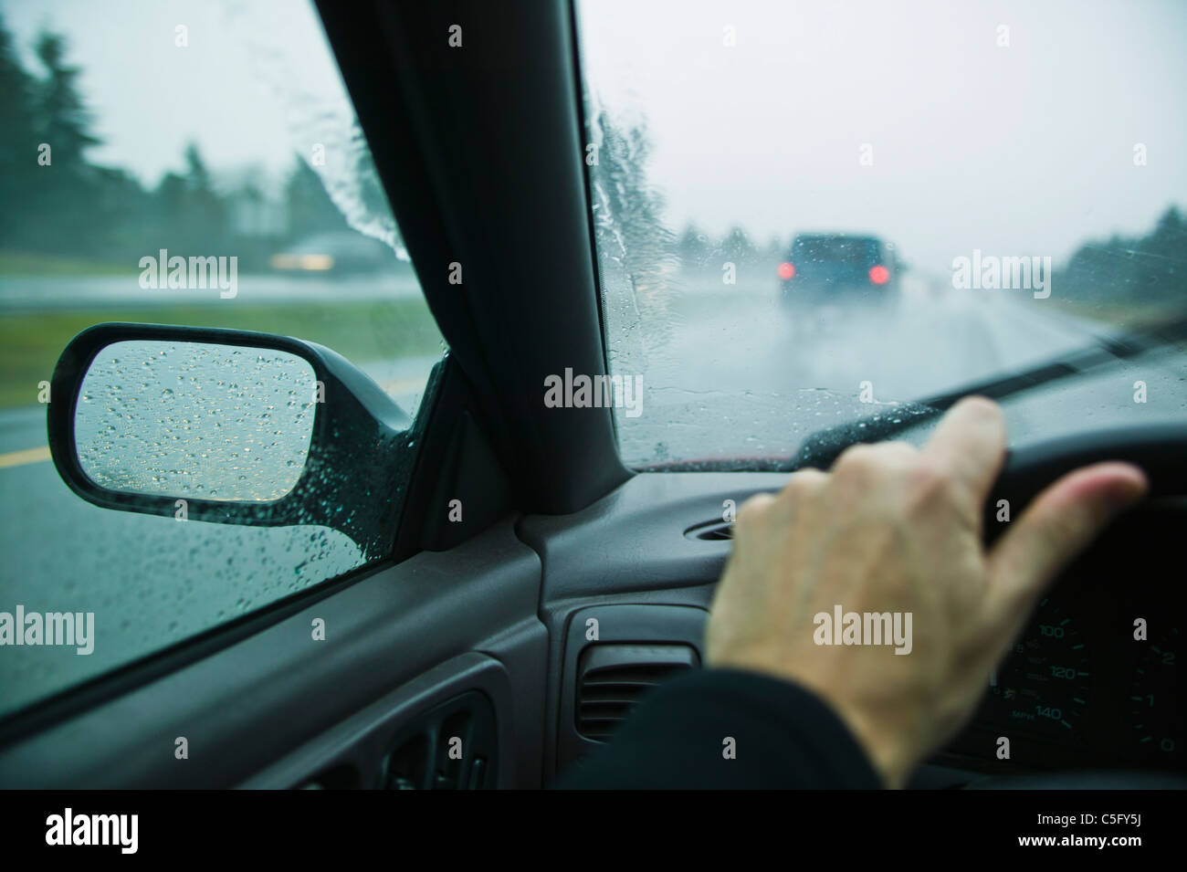 A first person perspective of driving on a freeway in the rain Stock ...