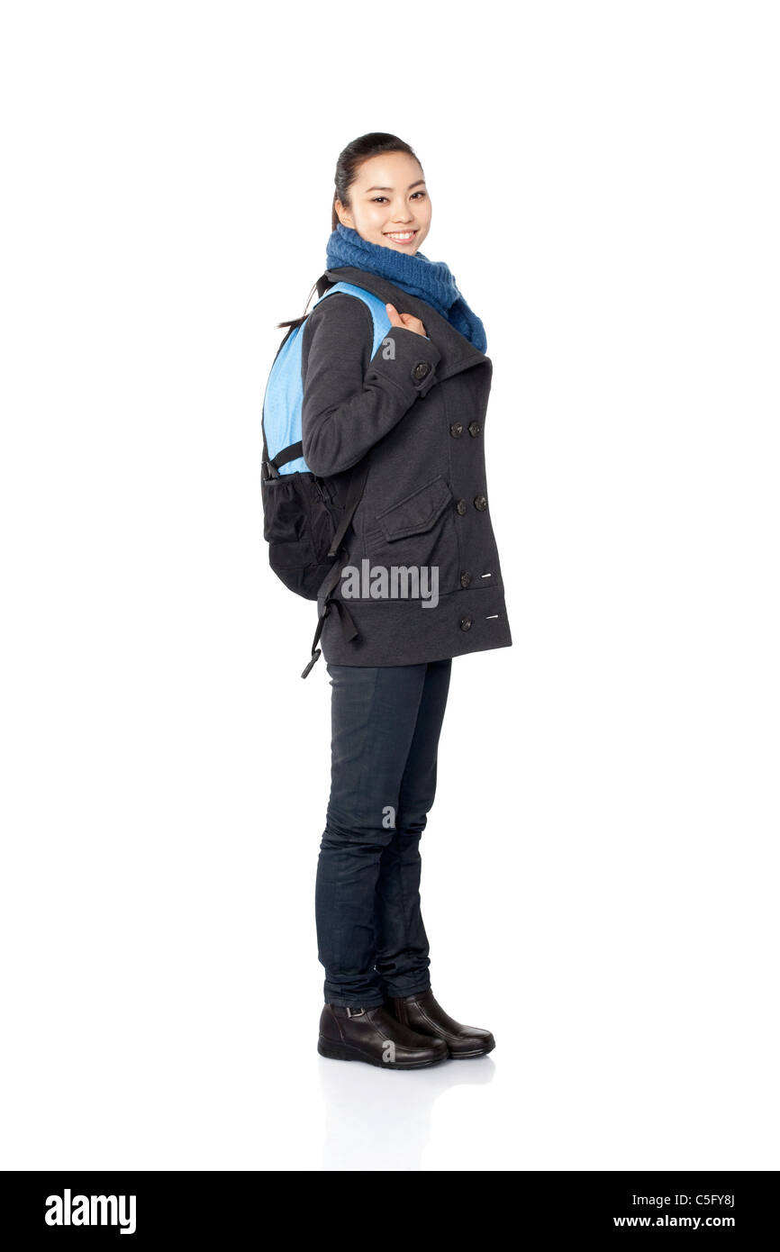 A young female student wearing a backpack, white background Stock Photo ...