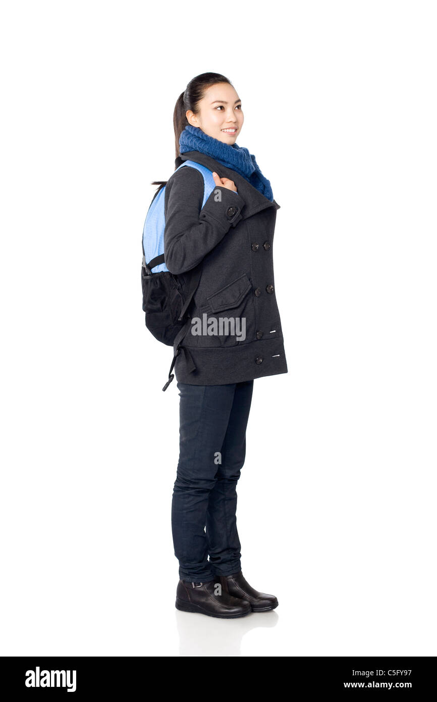 A young female student wearing a backpack, white background Stock Photo ...