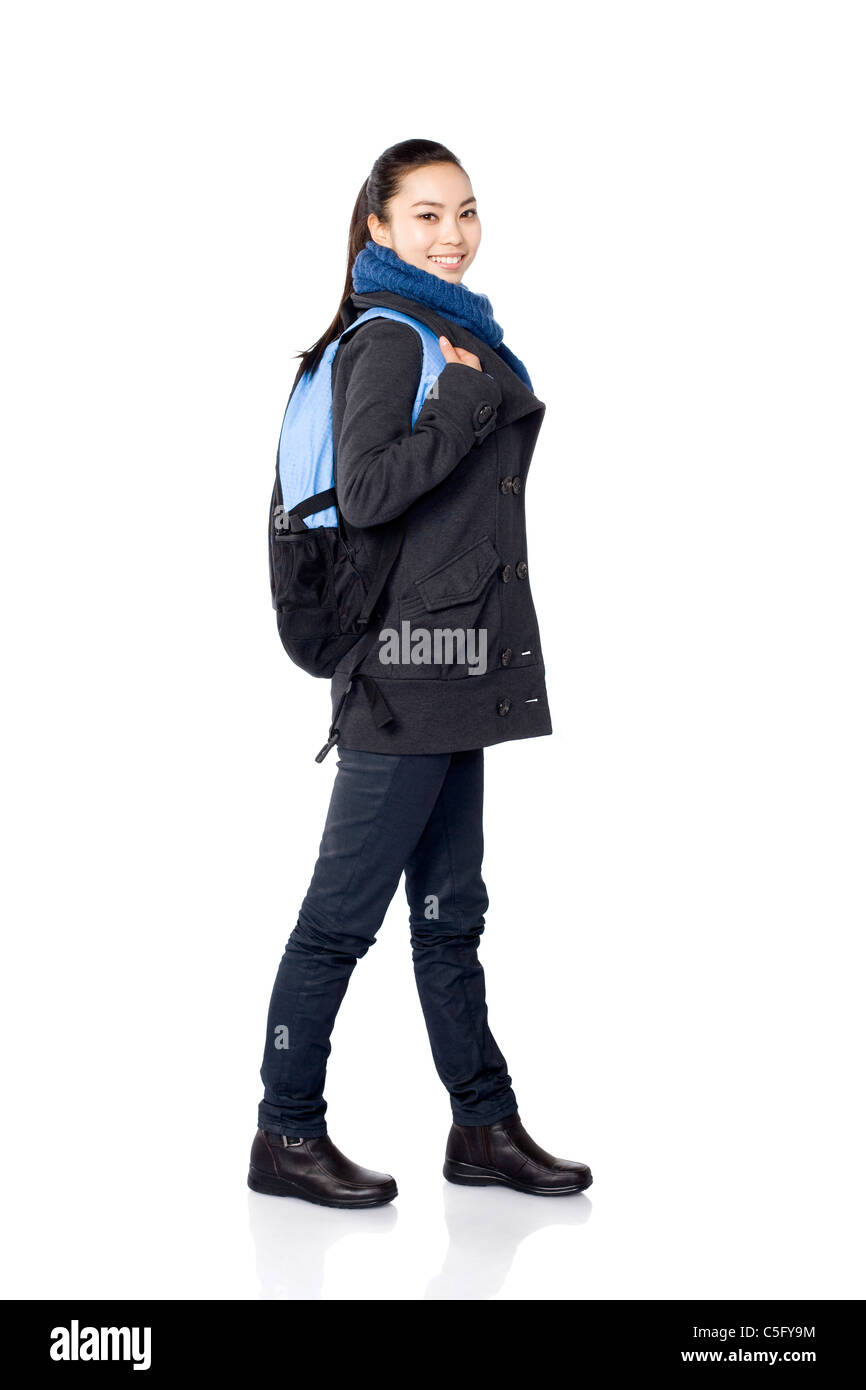 A young female student wearing a backpack, white background Stock Photo ...