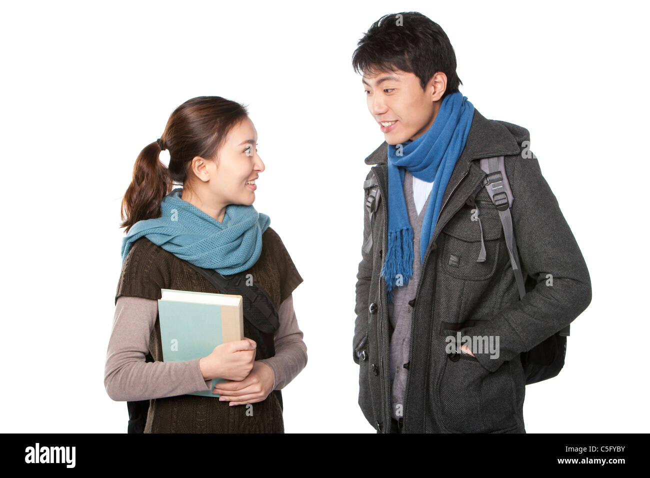 Two classmates talking, white background Stock Photo - Alamy