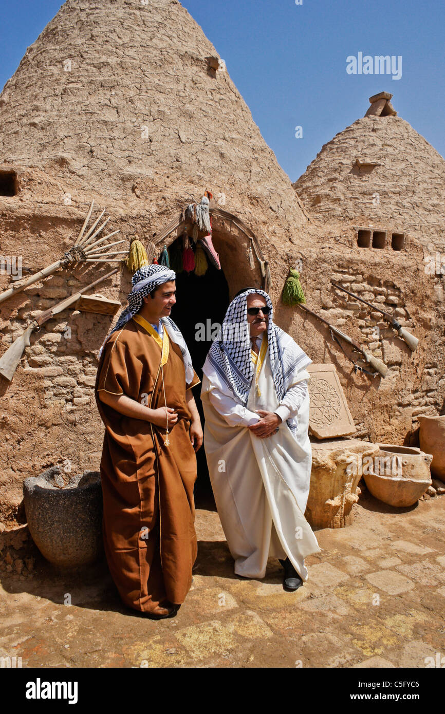 Men in front of traditional beehive house, Harran (Altinbasak), Eastern ...