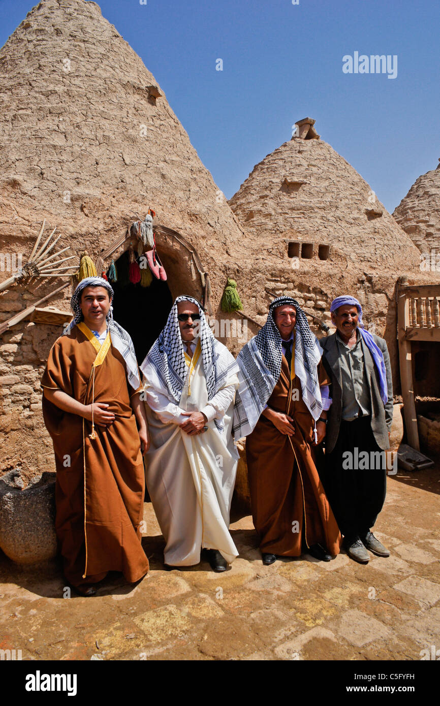 Men in front of traditional beehive house, Harran (Altinbasak), Eastern ...