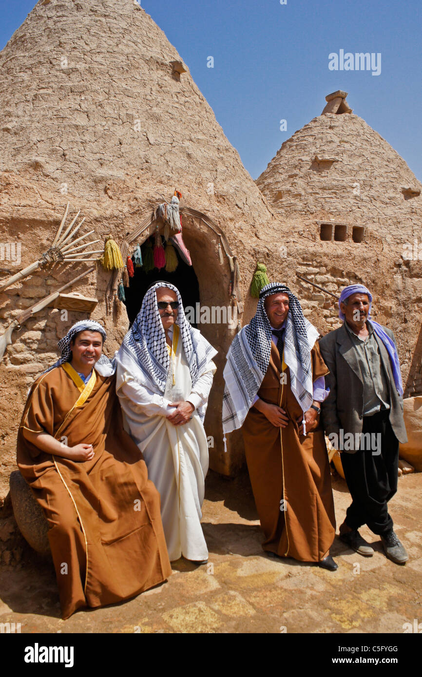 Men in front of traditional beehive house, Harran (Altinbasak), Eastern ...