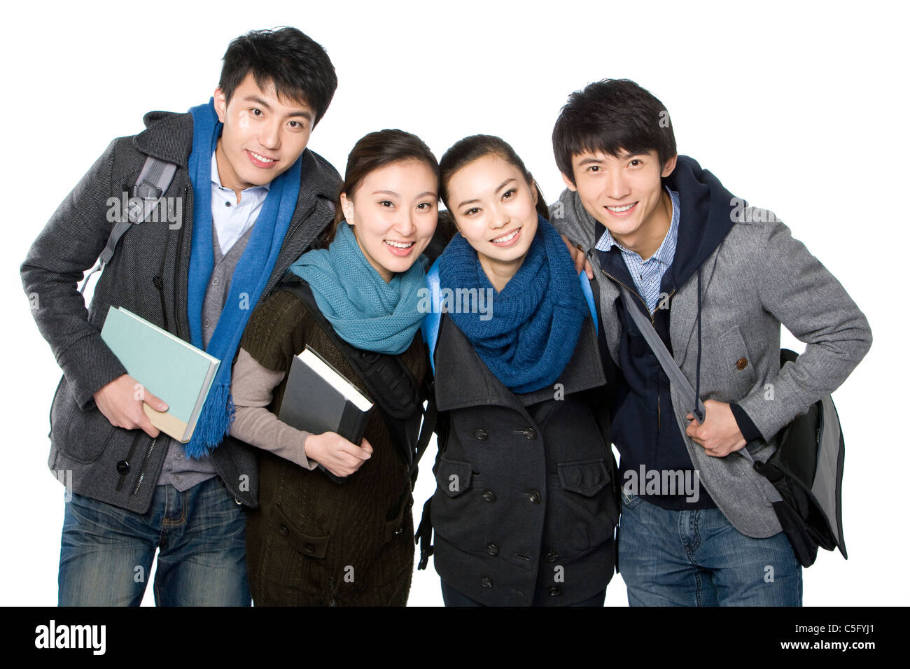 Four smiling classmates bunched up close, white background Stock Photo ...