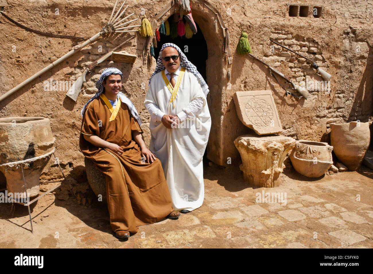 Men in front of traditional beehive house, Harran (Altinbasak), Eastern ...