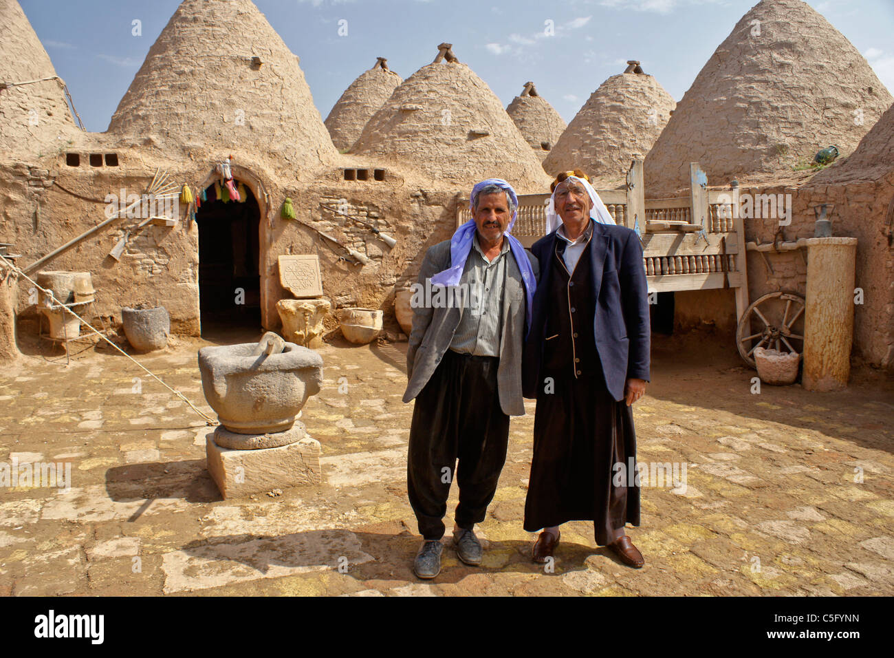 Men in front of traditional beehive house, Harran (Altinbasak), Eastern ...