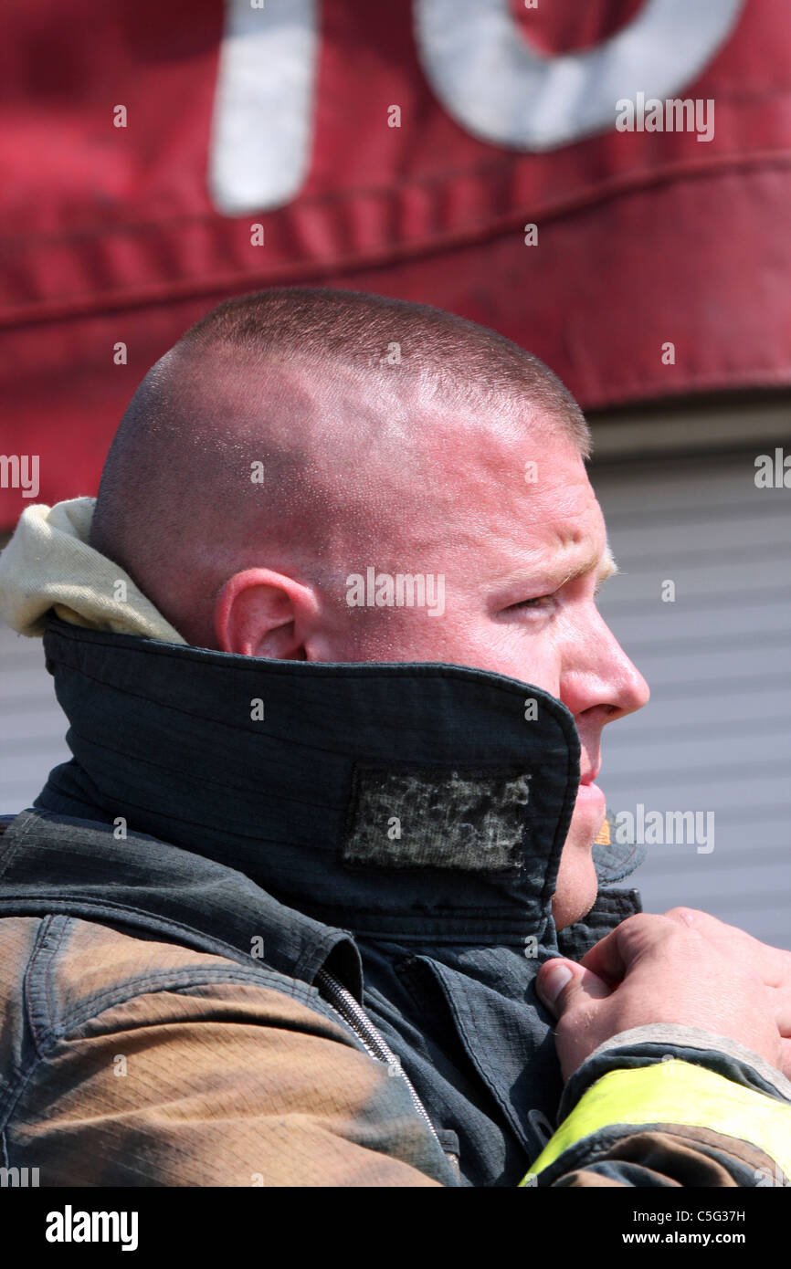 A male firefighter putting on his gear Stock Photo - Alamy