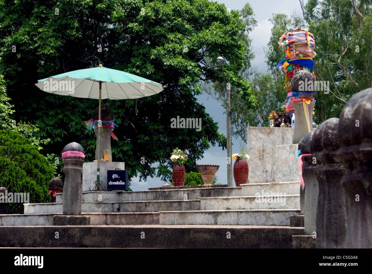 Buddhist objects form an outdoor altar display at a temple in Northern ...