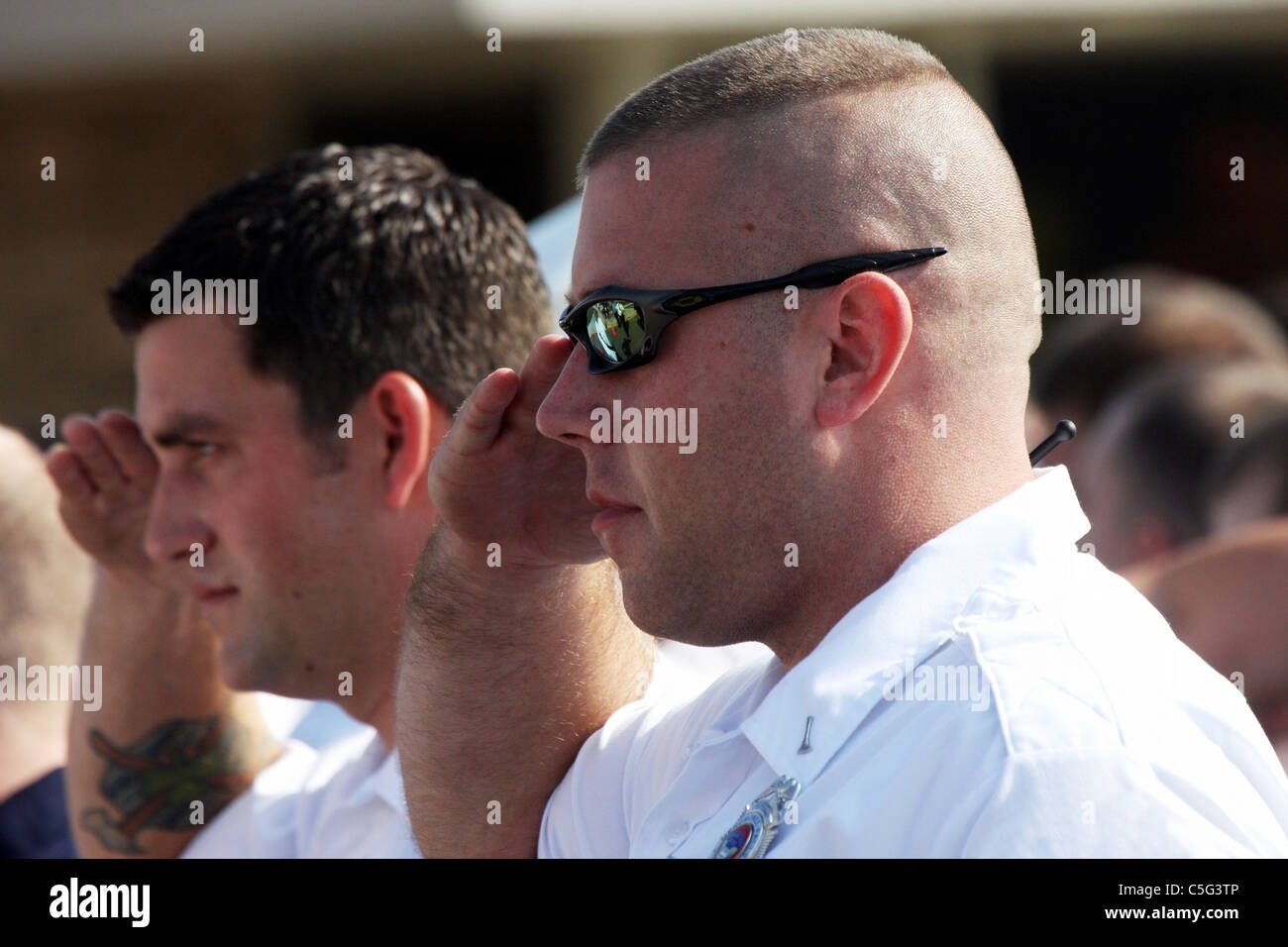 Fire fighters saluting in a line up roll call Stock Photo - Alamy