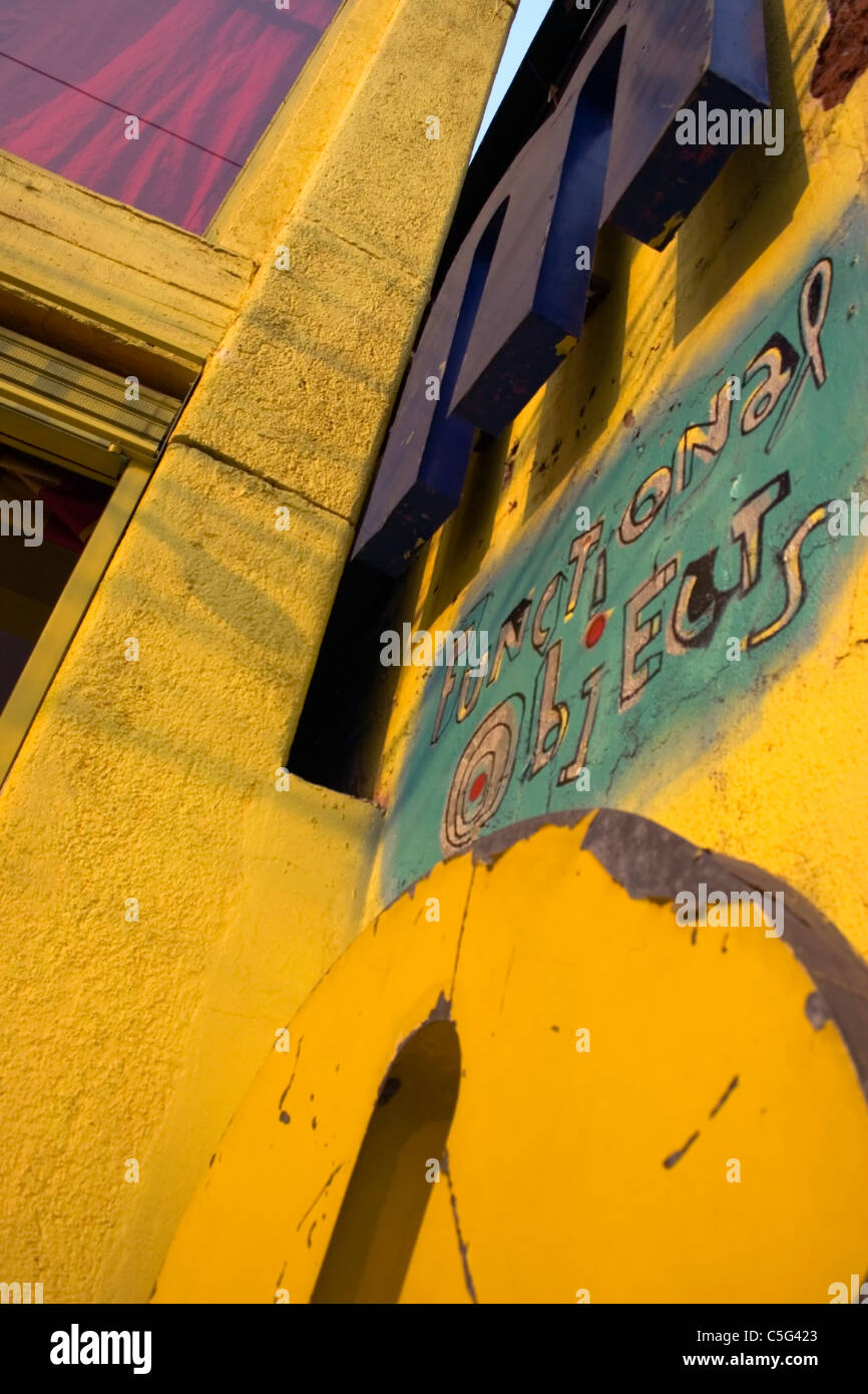A bright yellow shop is part of the urban landscape in a city in ...